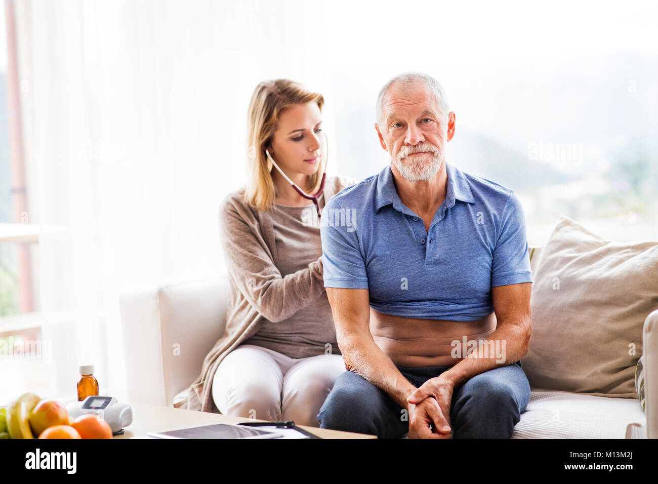 Health visitor and a senior man during home visit Stock Photo - Alamy