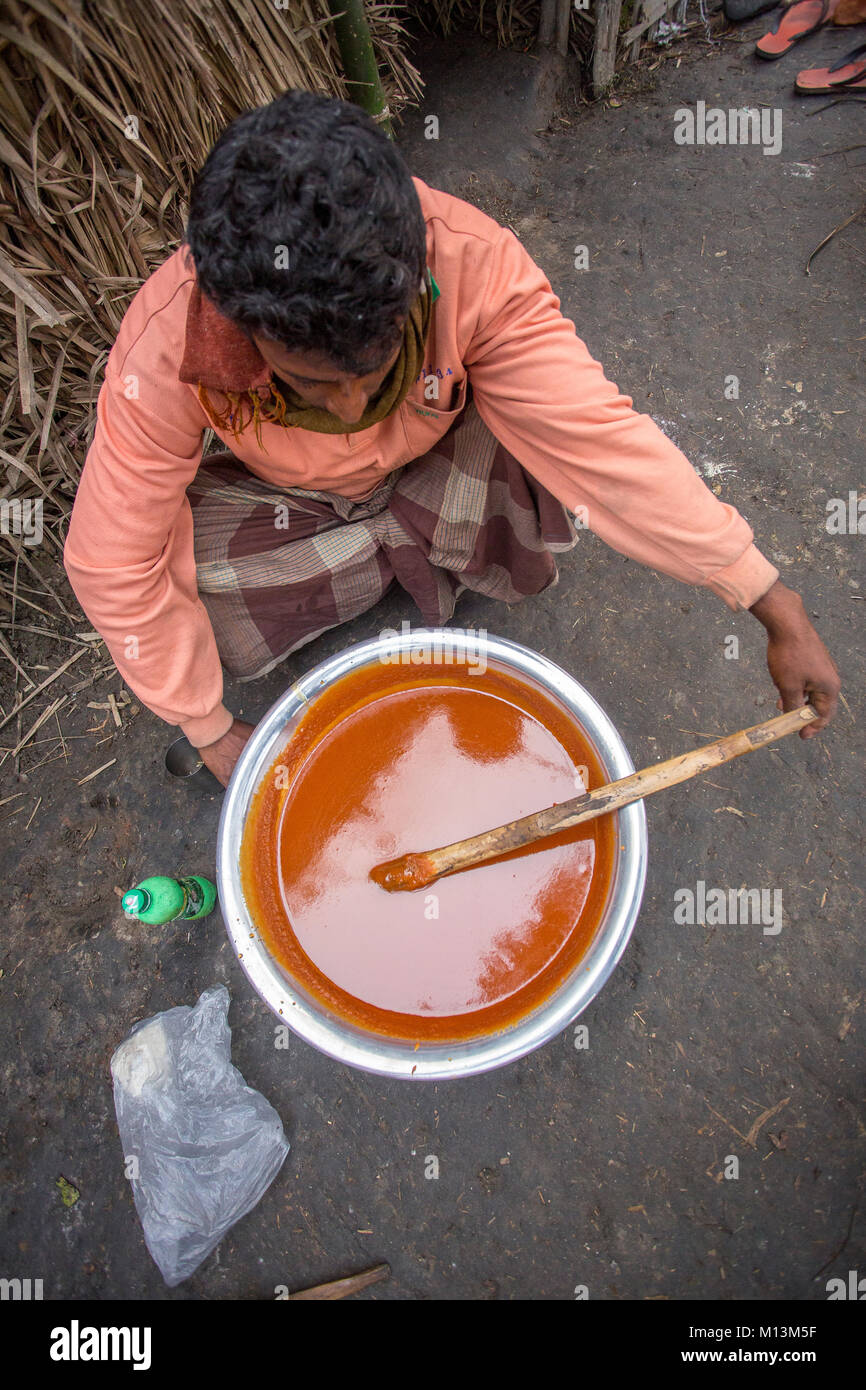 Golden Brown color Hot Boiled Date Palm Tree Molasses is mixing at ...