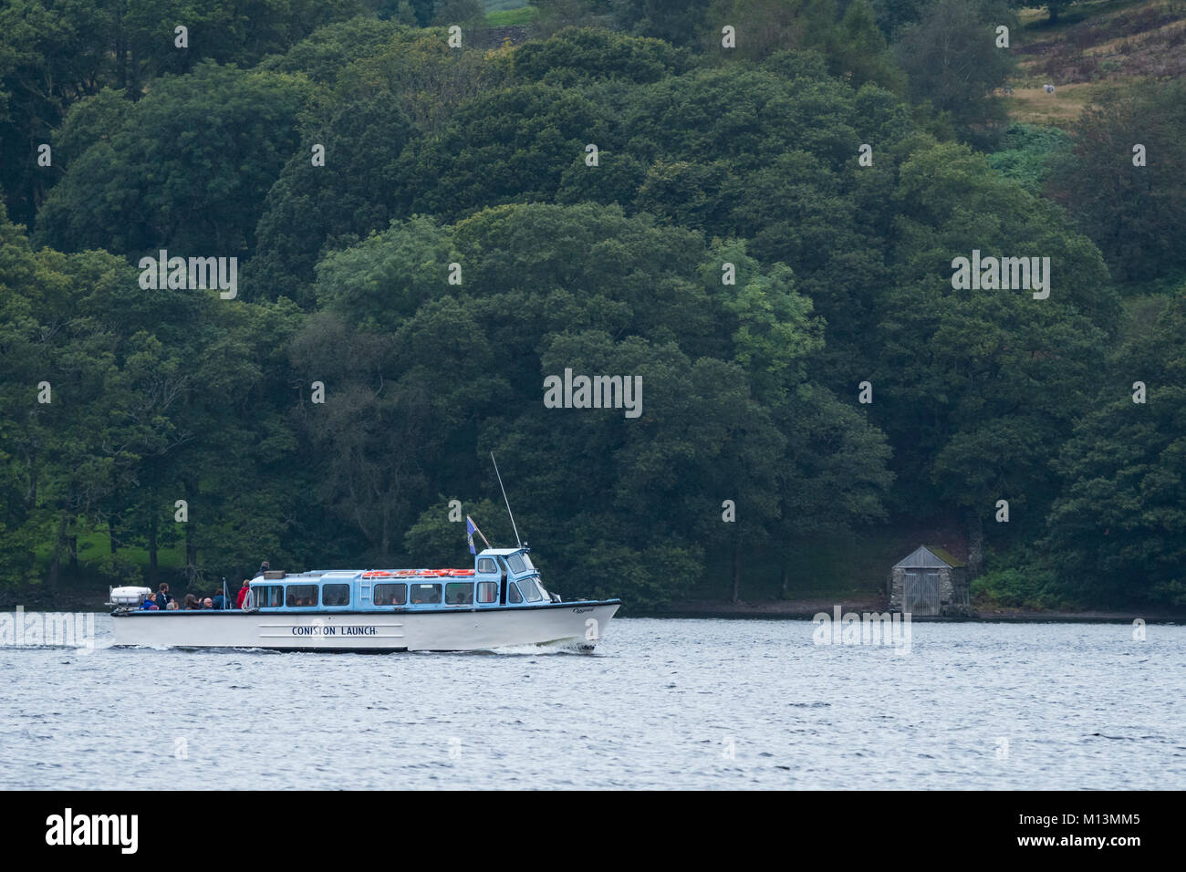 Passengers sailing on board Coniston Launch boat, use ferry service or ...