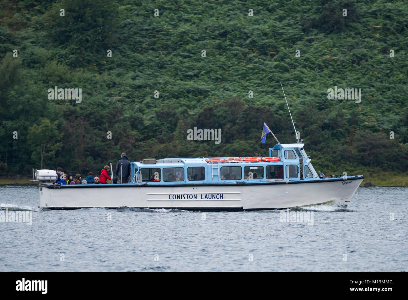 Passengers sailing on board Coniston Launch boat, use ferry service or ...