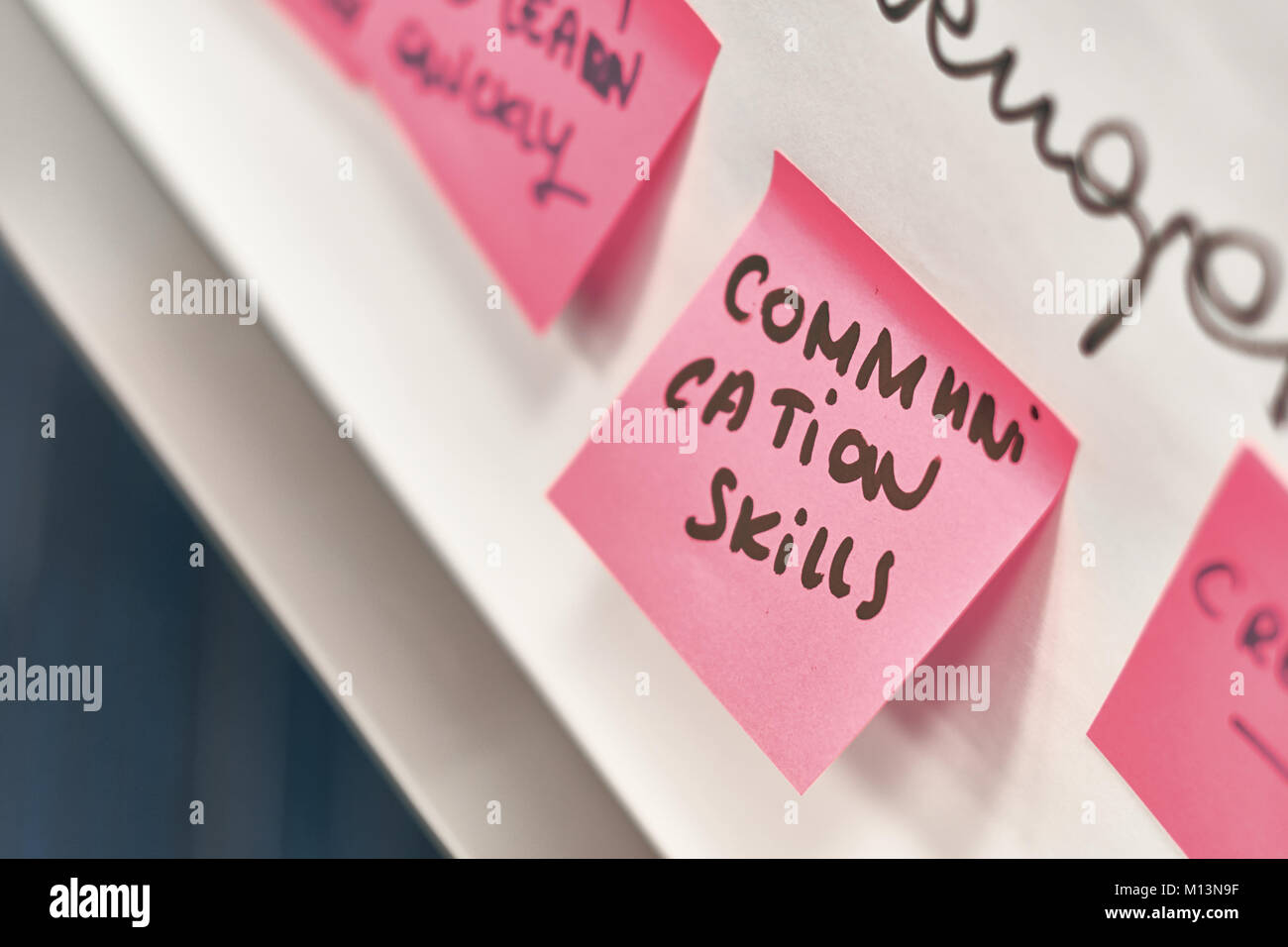 Communication skills written on pink paper stickers attached to a flip ...
