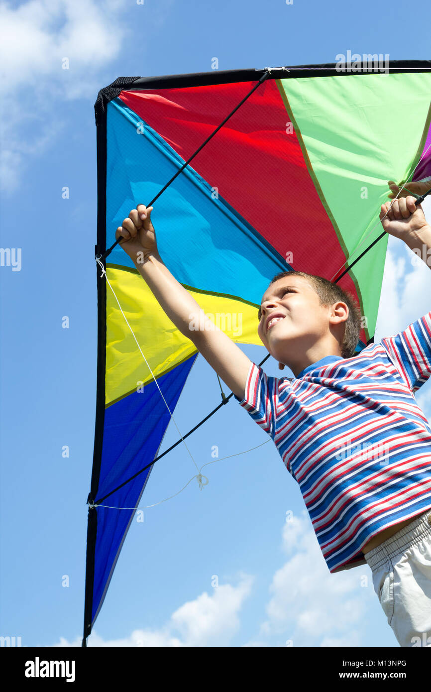 Happy little boy flies a kite in the sunny sky Stock Photo - Alamy