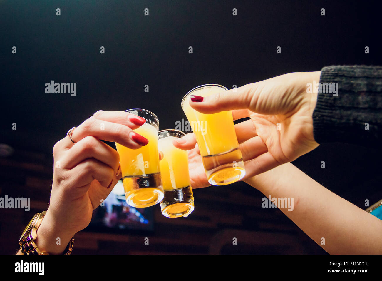 Girls making a toast with tequila shots Stock Photo - Alamy