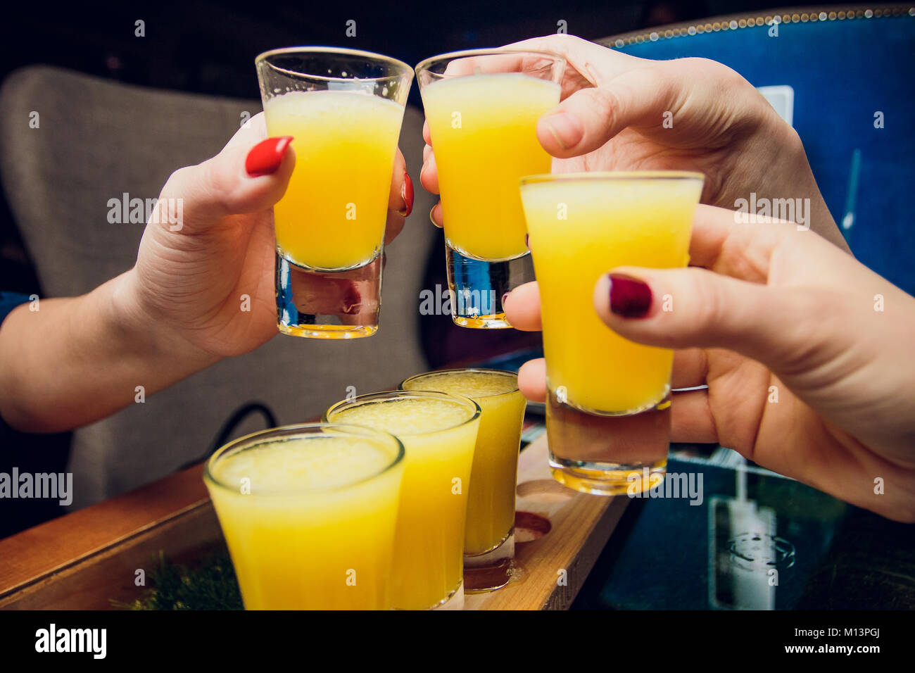 Girls making a toast with tequila shots Stock Photo - Alamy