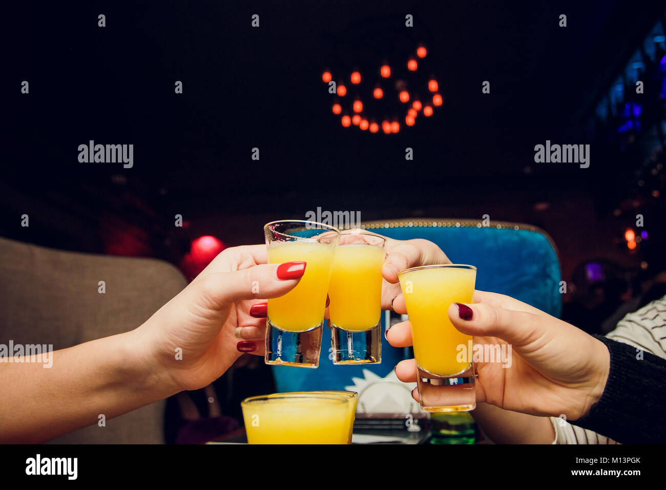 Girls making a toast with tequila shots Stock Photo - Alamy