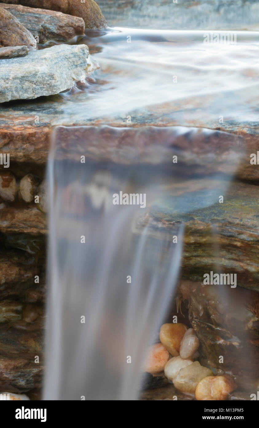 Water flowing over a small cascade with lots or rocks Stock Photo - Alamy