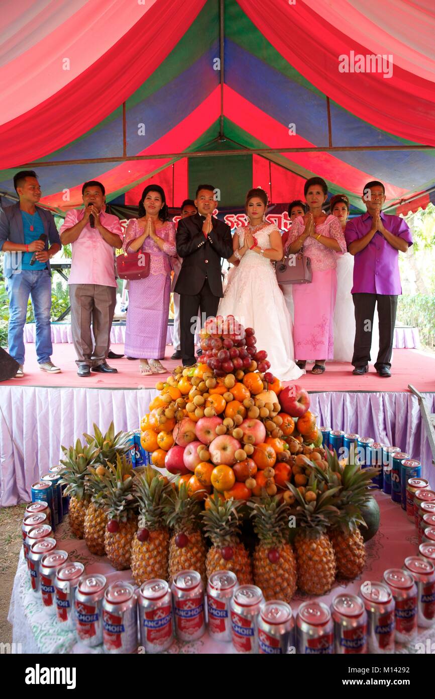 Cambodia, Battambang, married and their families on a dais and in front ...