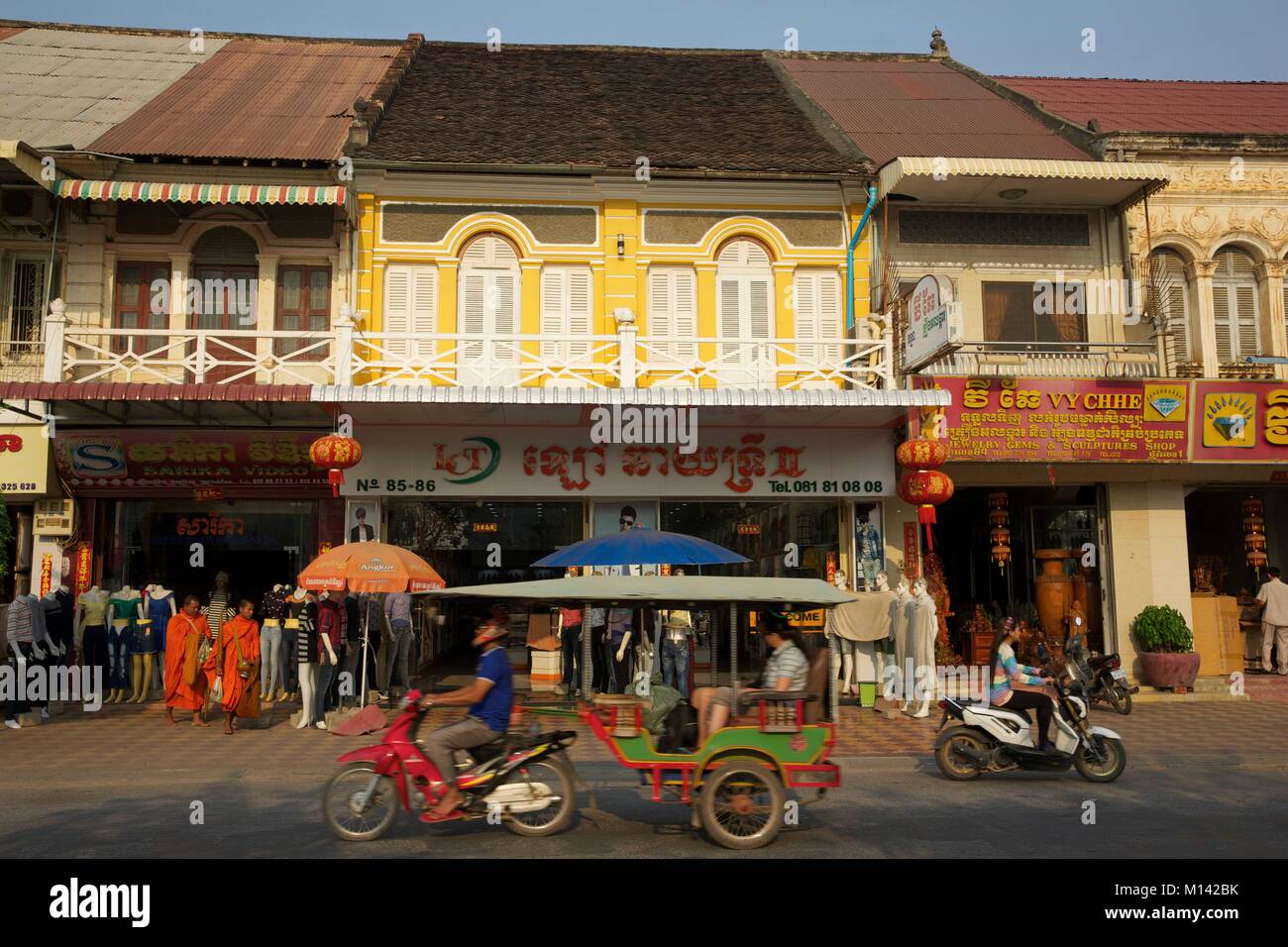 Cambodia, Battambang, rickshaw passing in front of french colonial ...