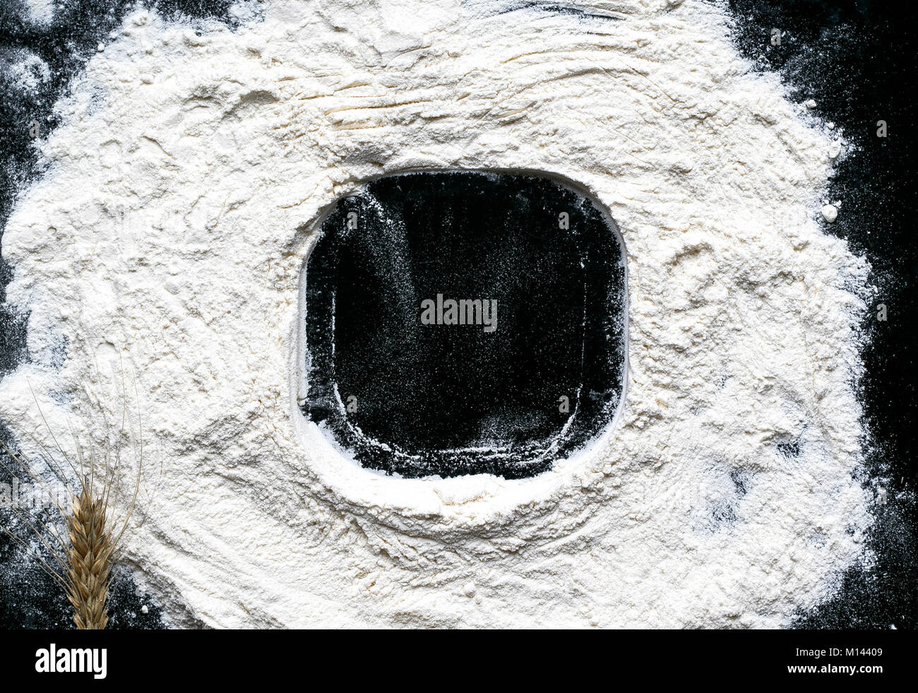 culinary background with frame of Golden wheat ears lying on a white ...