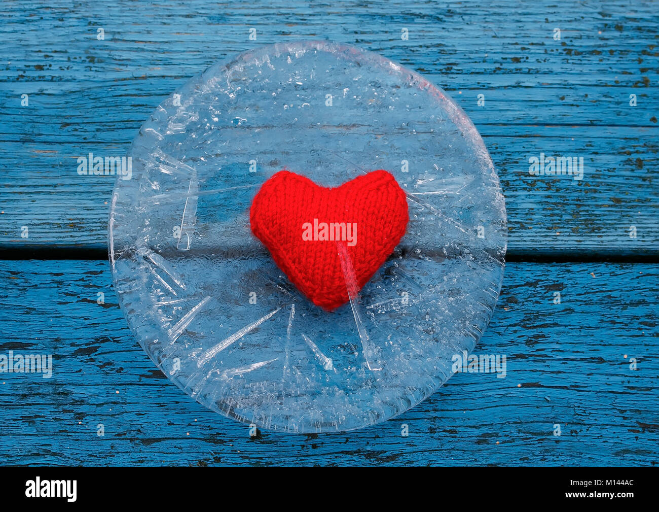 the warm red heart lies surrounded by the sharp cold of ice on a blue ...
