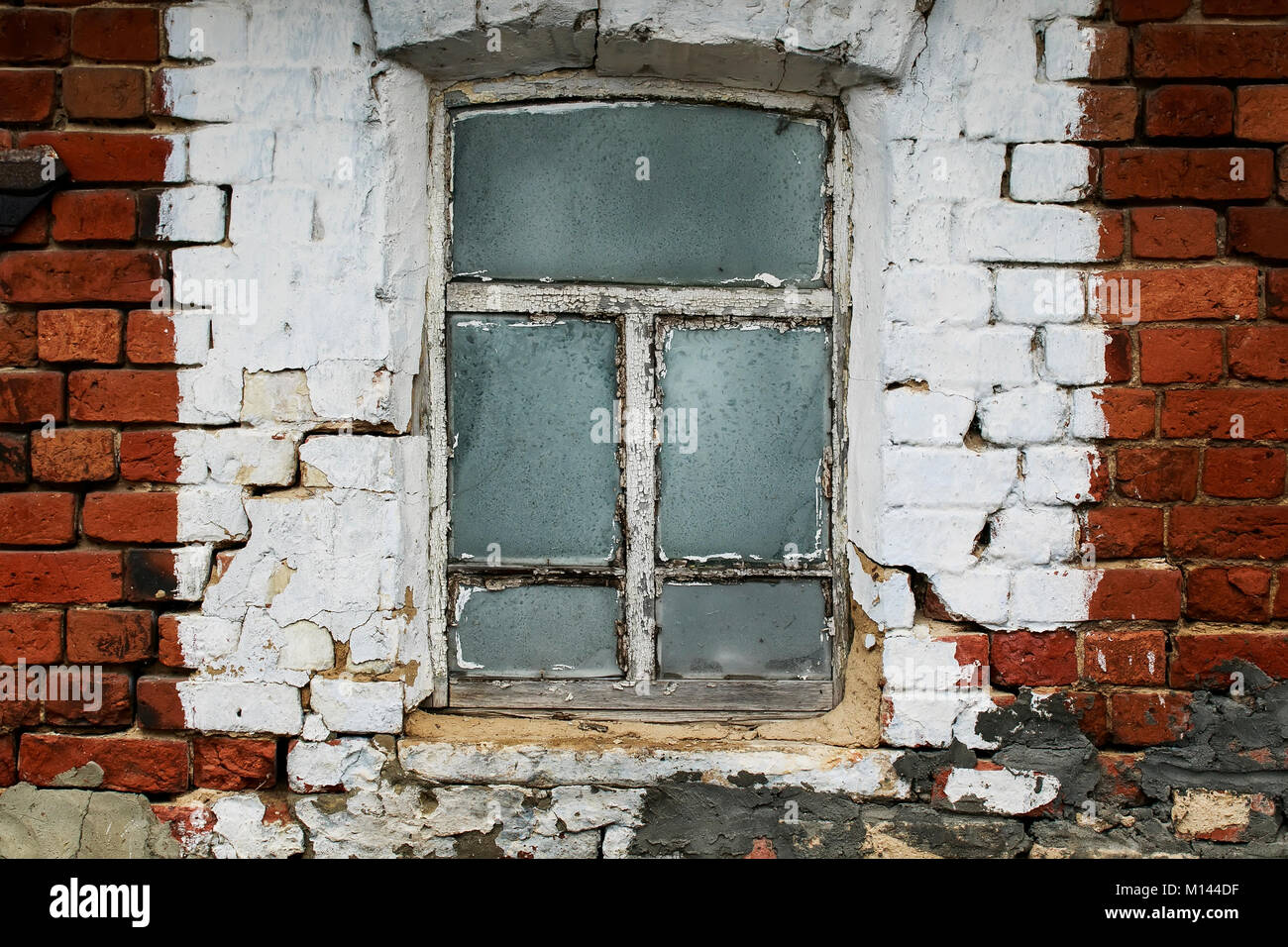 an old window with a rickety wooden frame in the brick wall of a ...