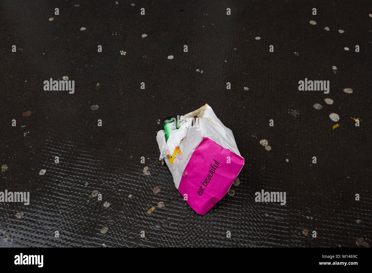 A discarded lunch bag with the words 'Eat Beautiful' on the outside, on ...