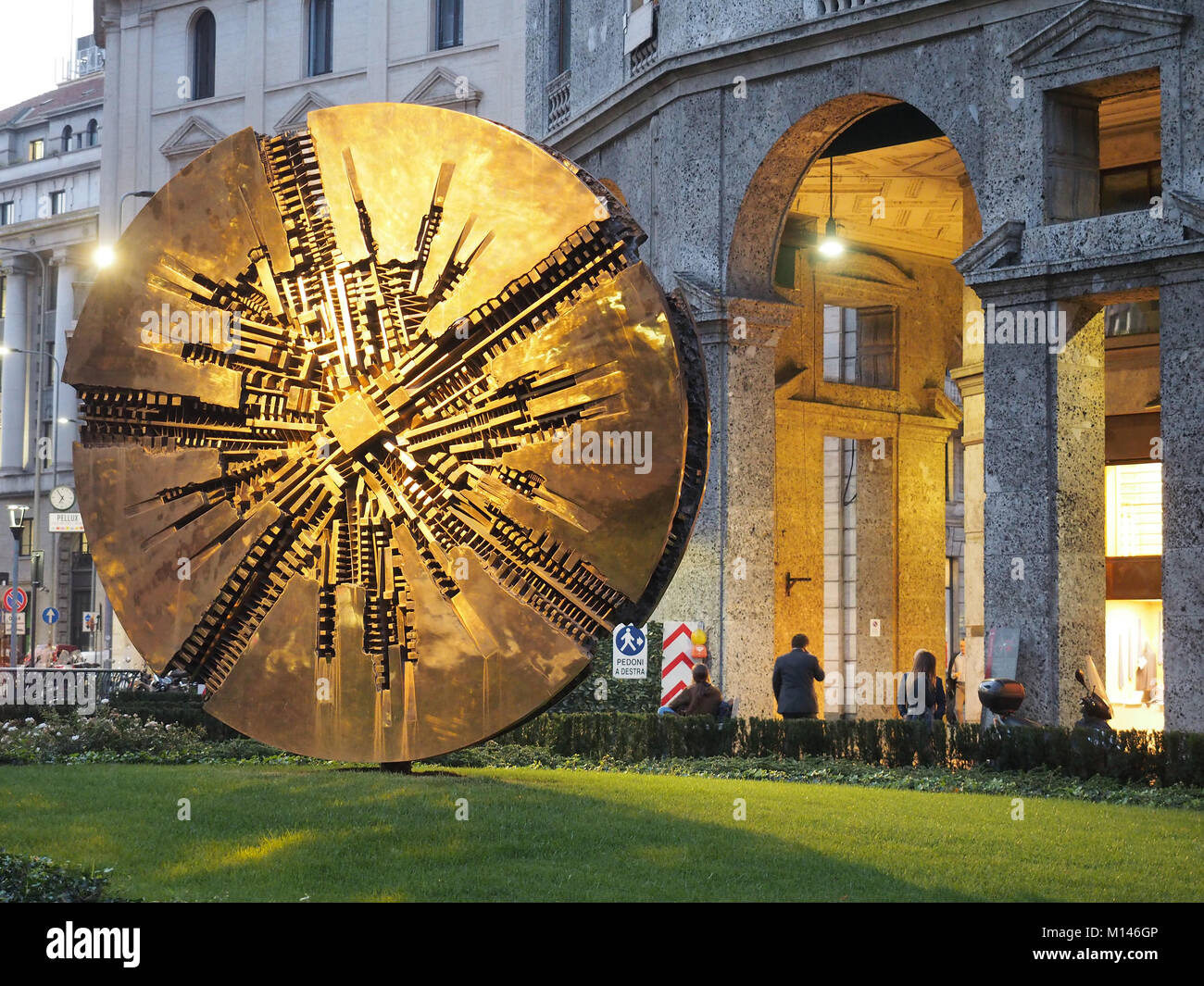 Europe,Italy,Lombardy,Milan,Arnoldo Pomodoro bronze disc sculpture in ...