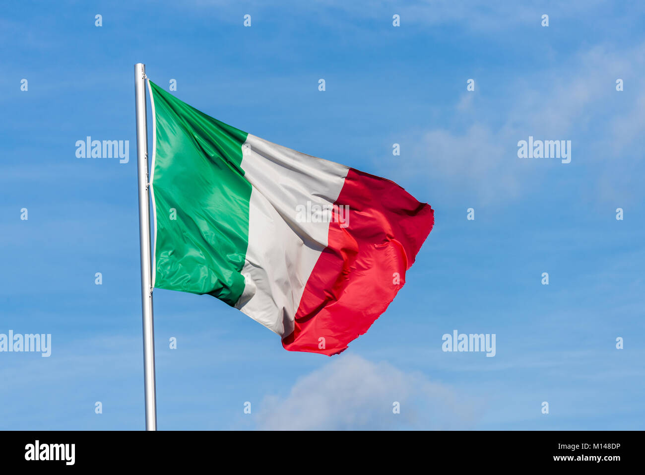 Closeup of single italian tricolor flag waving in the wind in front of ...