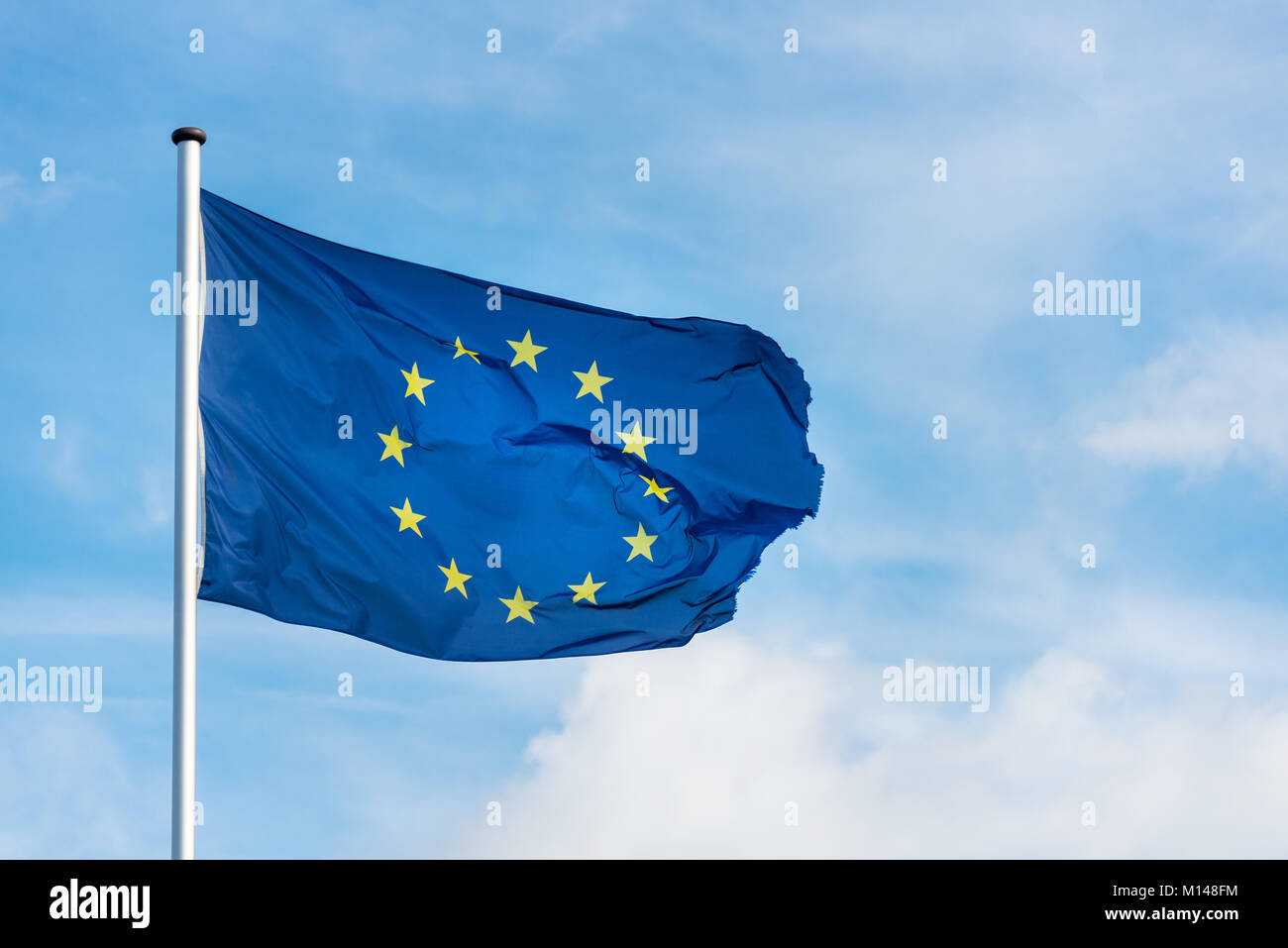 Closeup of single european flag with twelve yellow stars waving in the ...
