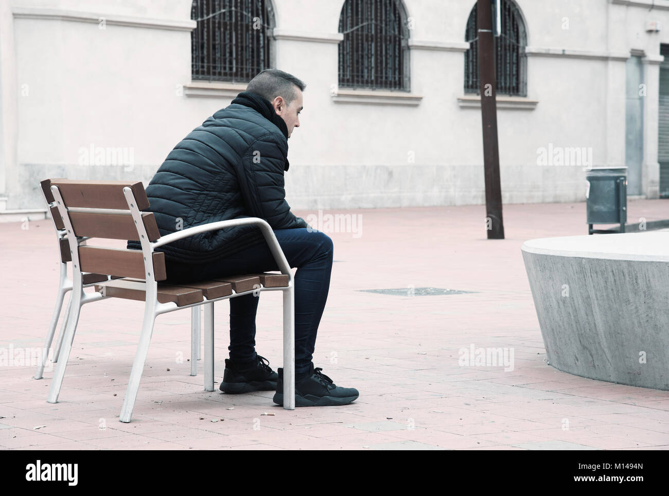 Depressed man sitting street hi-res stock photography and images - Alamy