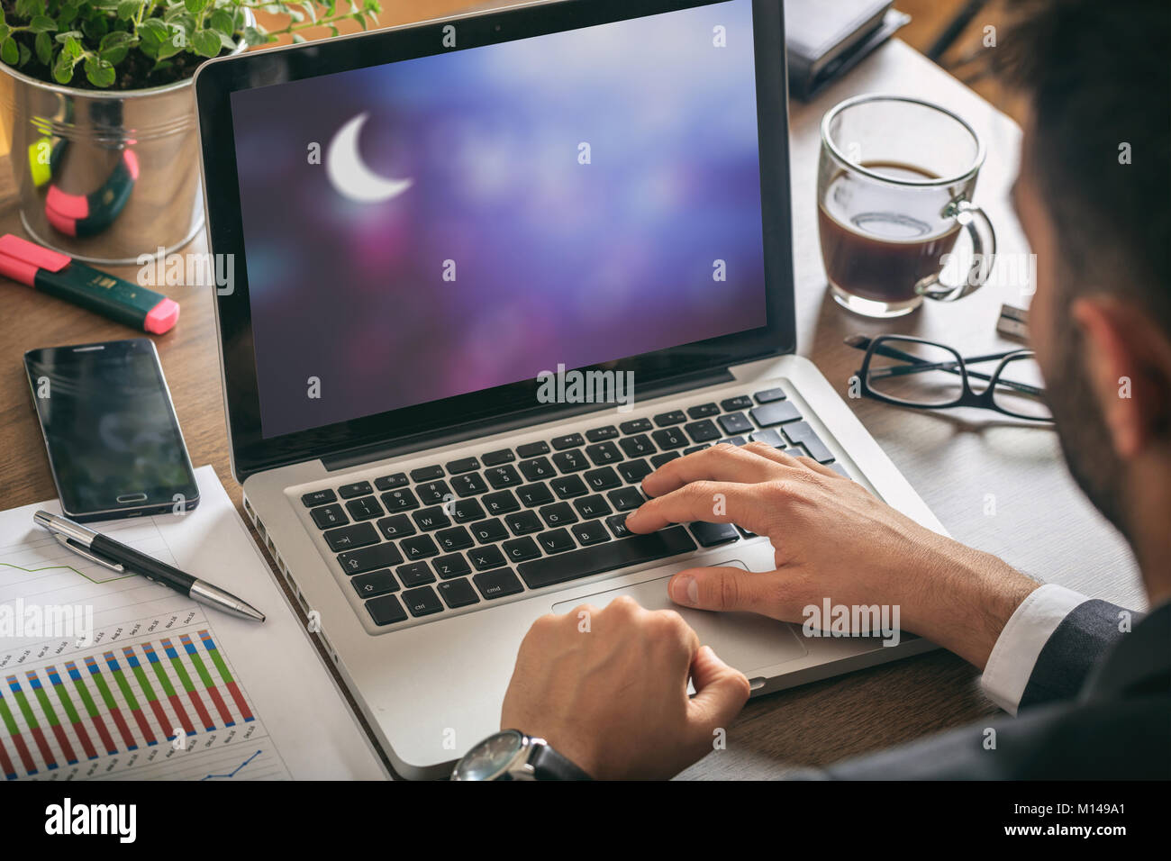 Man working in the office. Crescent moon on blue sky background on the ...