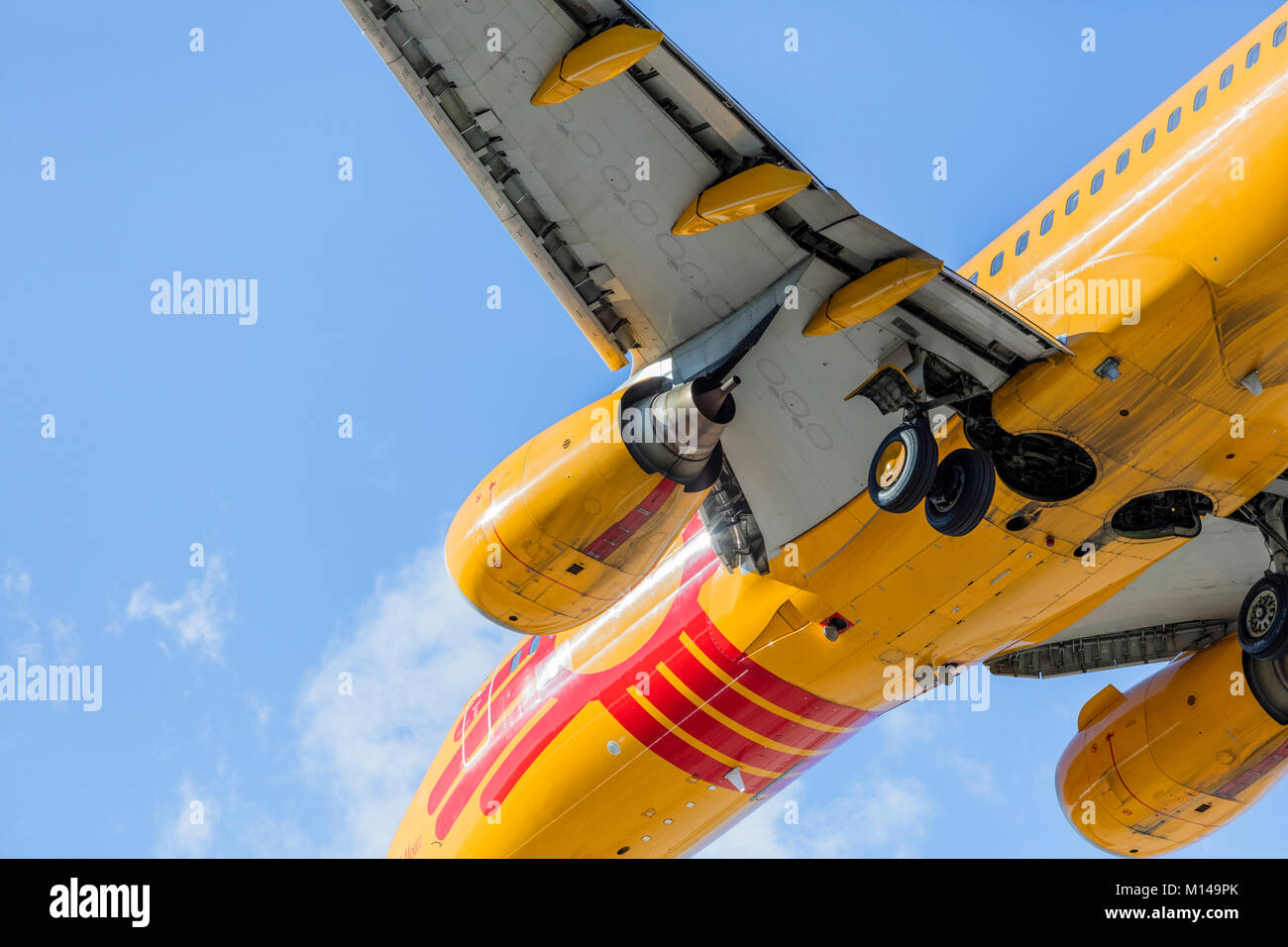 Commercial passenger jet coming in for landing as seen from under the ...