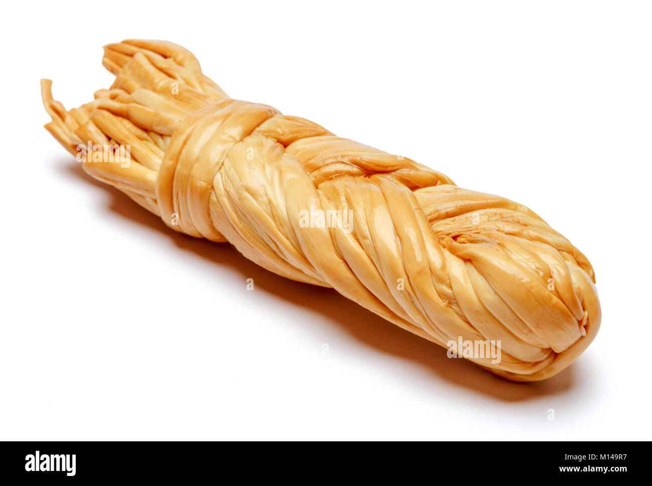 Smoked braided cheese isolated on white background Stock Photo - Alamy