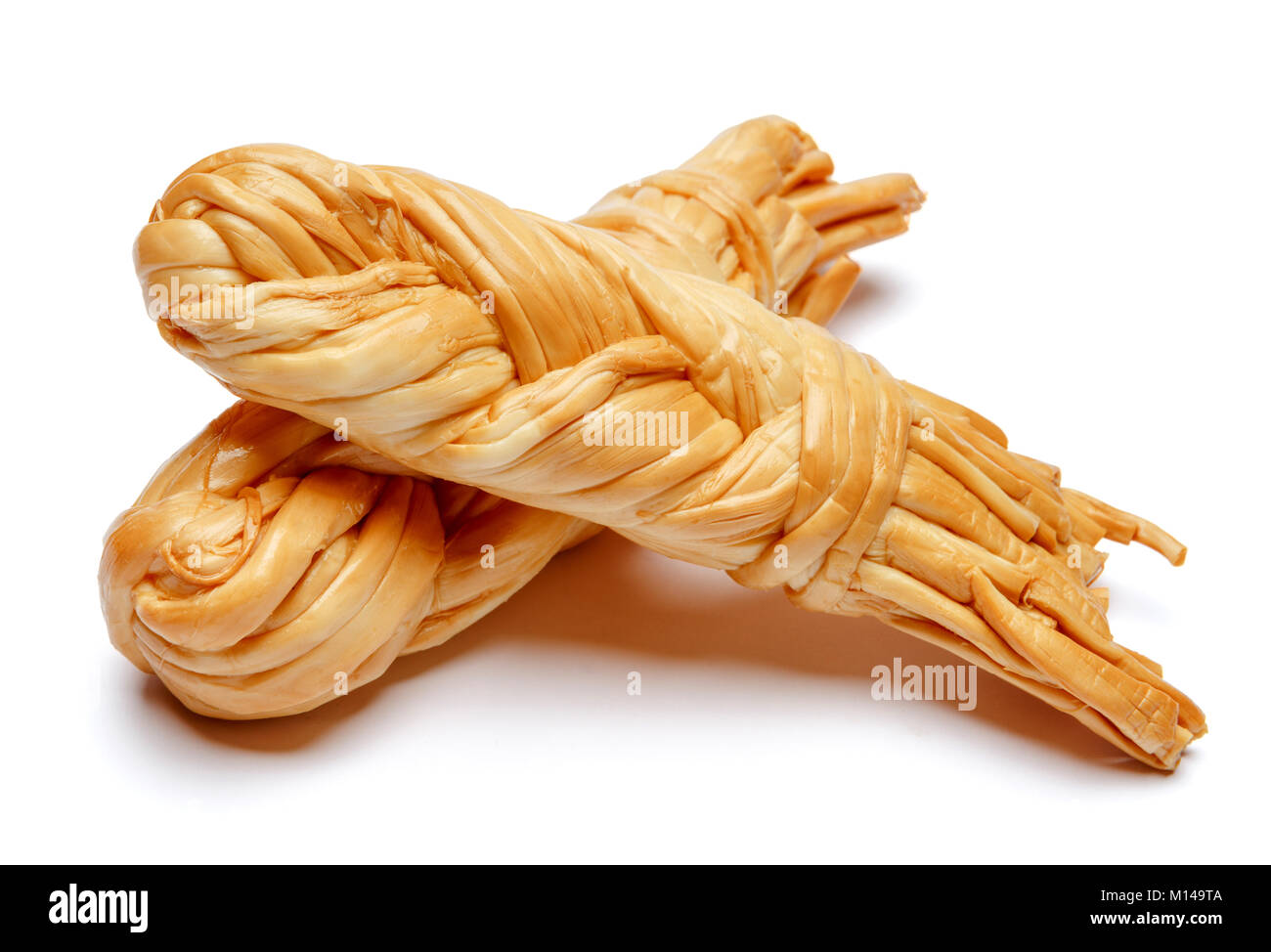 Smoked braided cheese isolated on white background Stock Photo - Alamy
