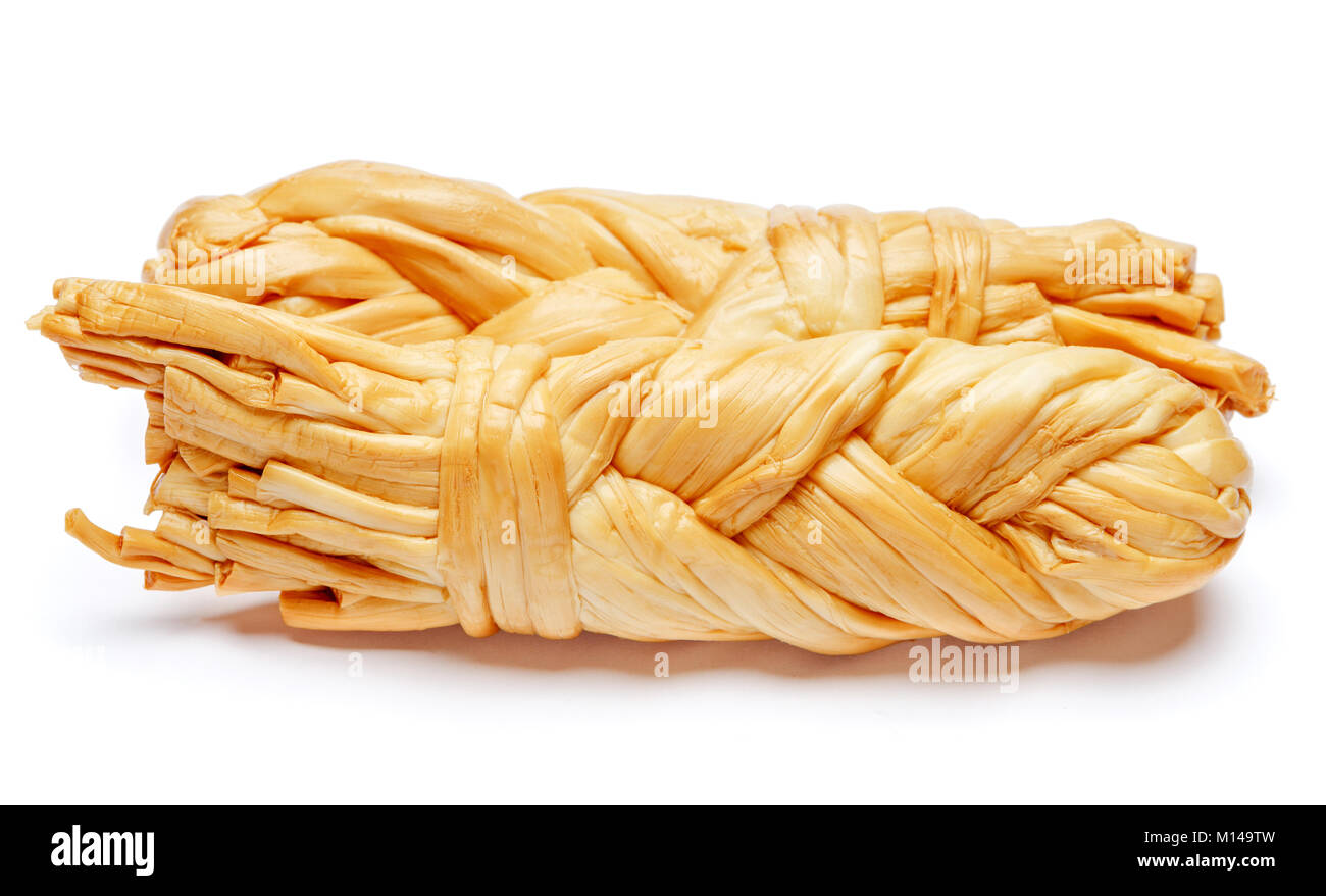 Smoked braided cheese isolated on white background Stock Photo - Alamy