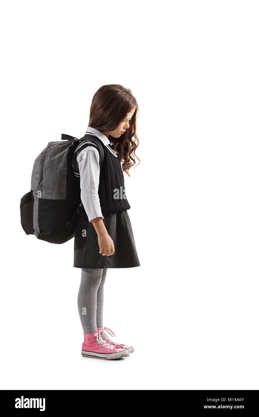 Full length profile shot of a sad little schoolgirl with a backpack ...
