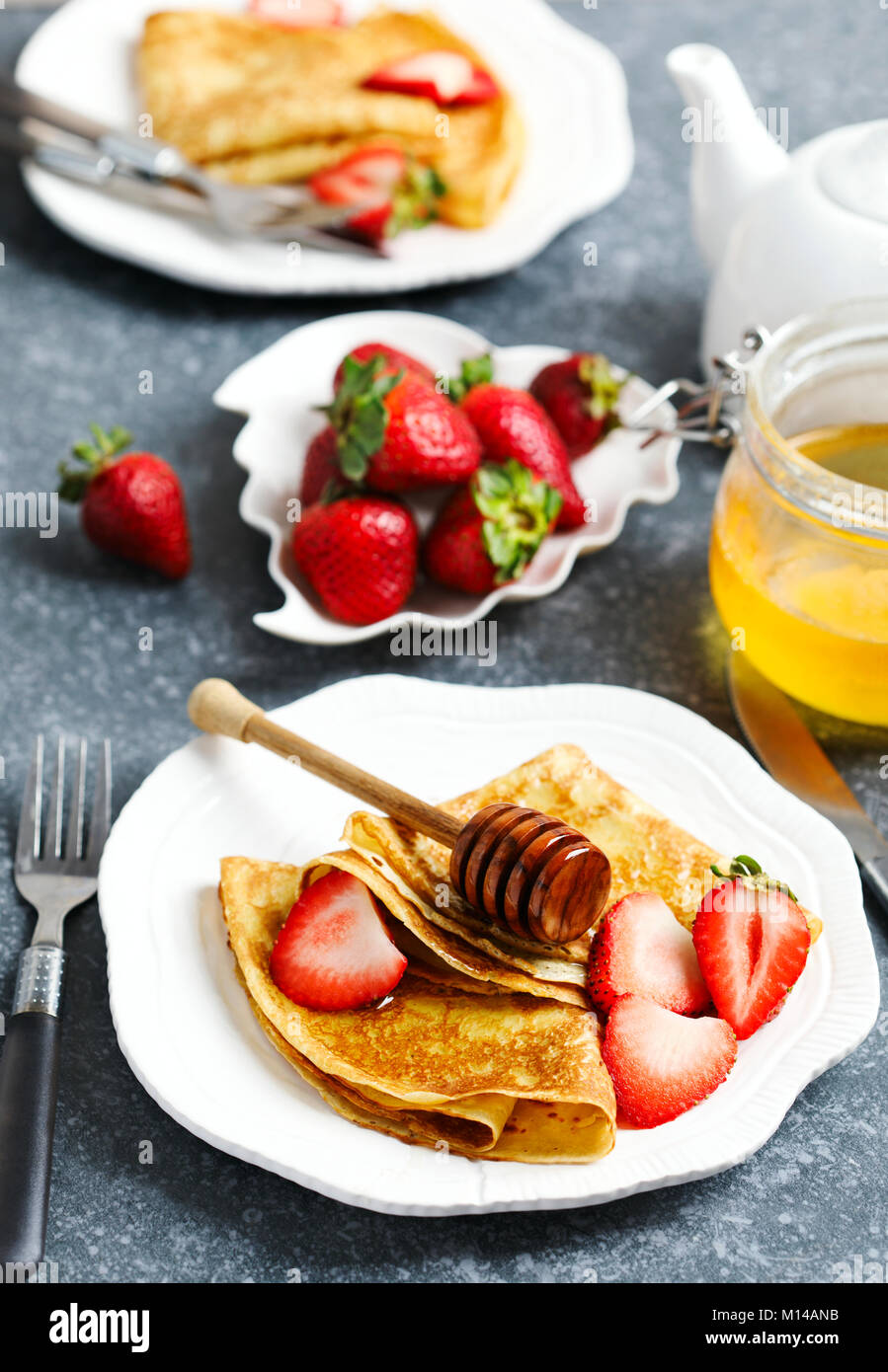 Crepes with berries and honey Stock Photo - Alamy