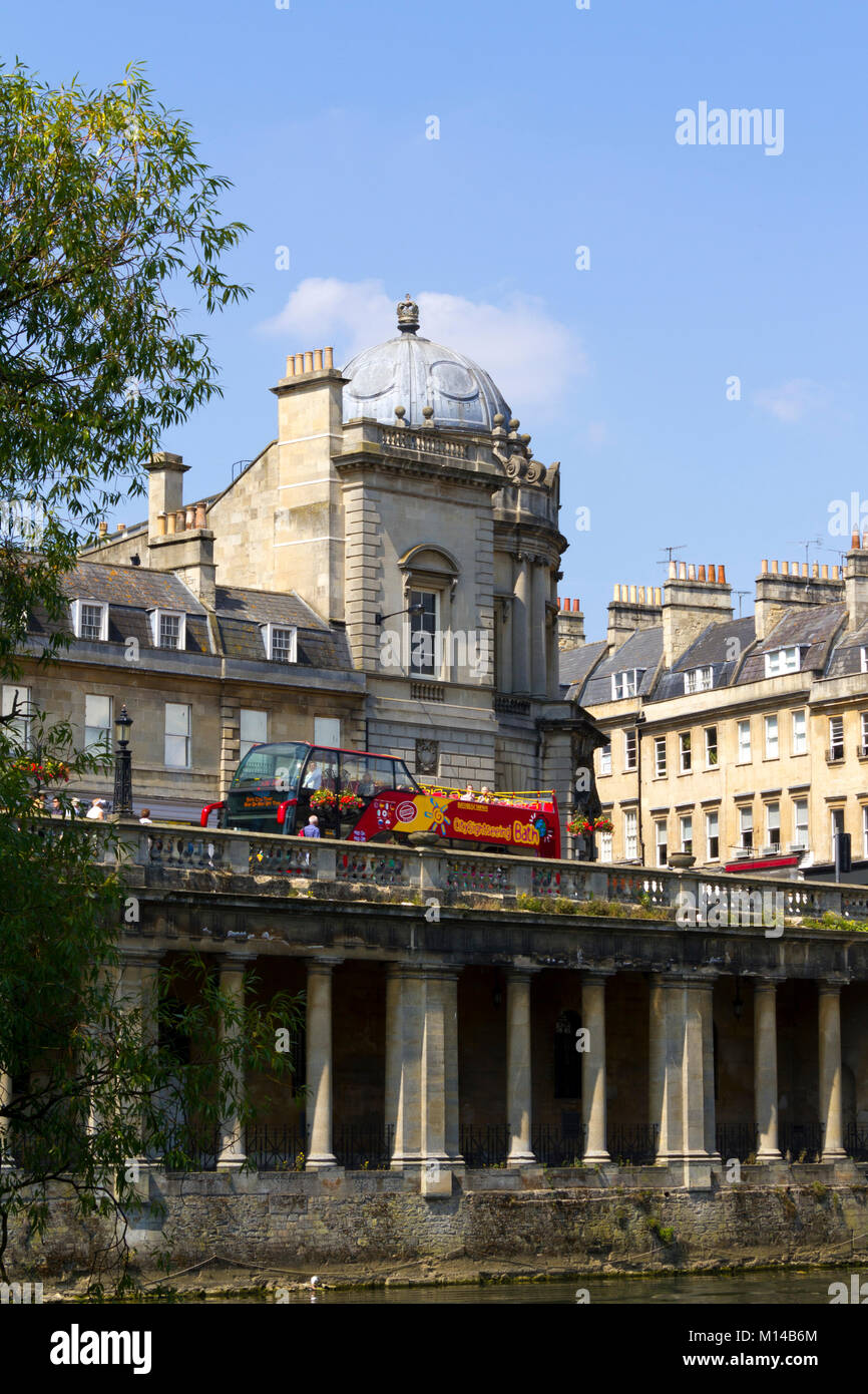 Bath, UK - 3rd July 2011: A bright red open-topped tour bus passes ...