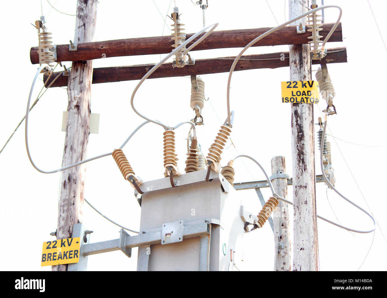 Close-up of wooden electricity pylon showing transformer, insulators ...