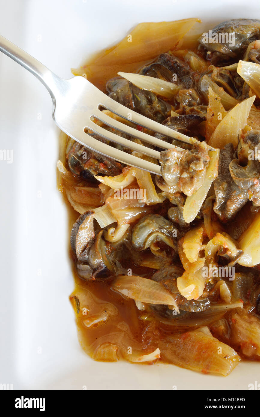 Stew of snail and fork Stock Photo - Alamy