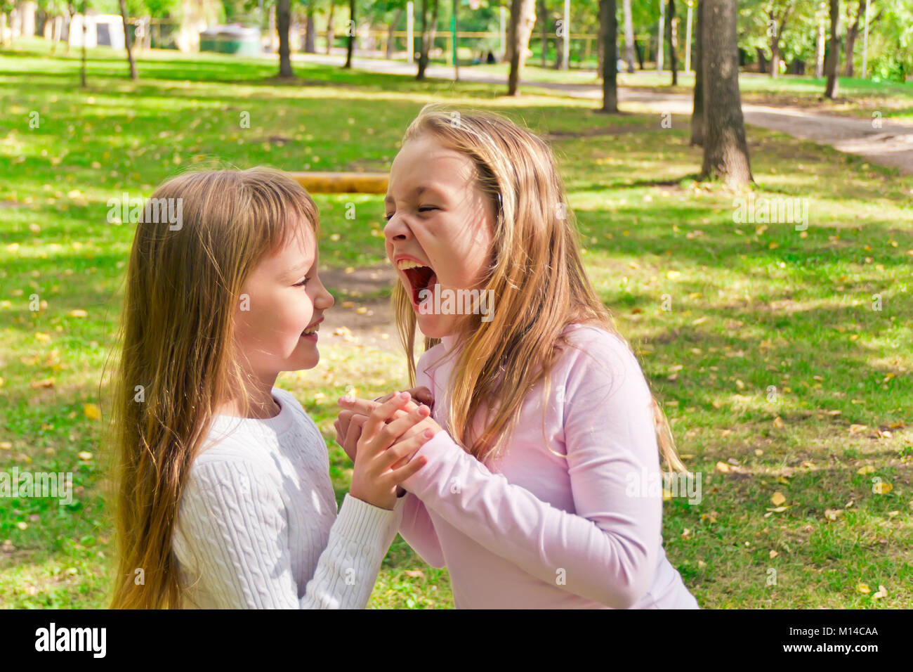 Photo of two playing girls in summer Stock Photo - Alamy