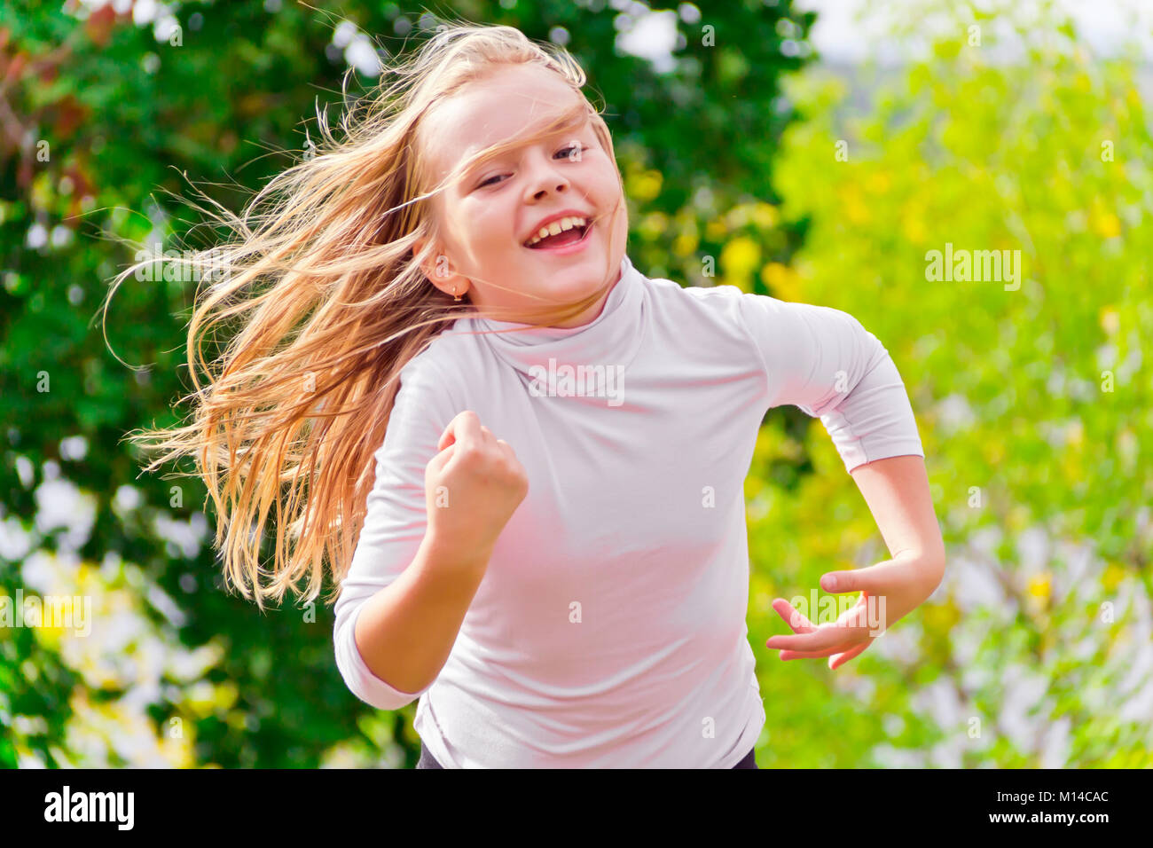 Photo of cute running girl in summer Stock Photo - Alamy