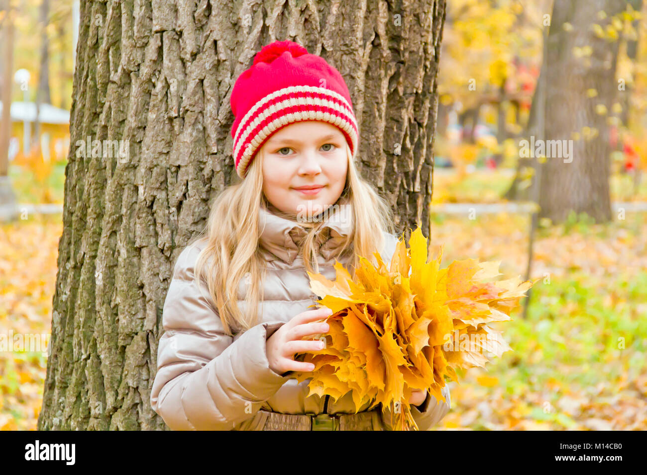 Photo of cute smiling girl in autumn Stock Photo - Alamy