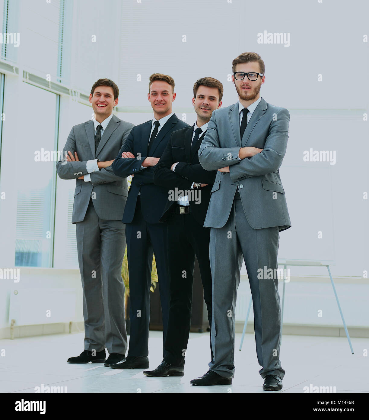 Business team in a line smiling at the camera Stock Photo - Alamy