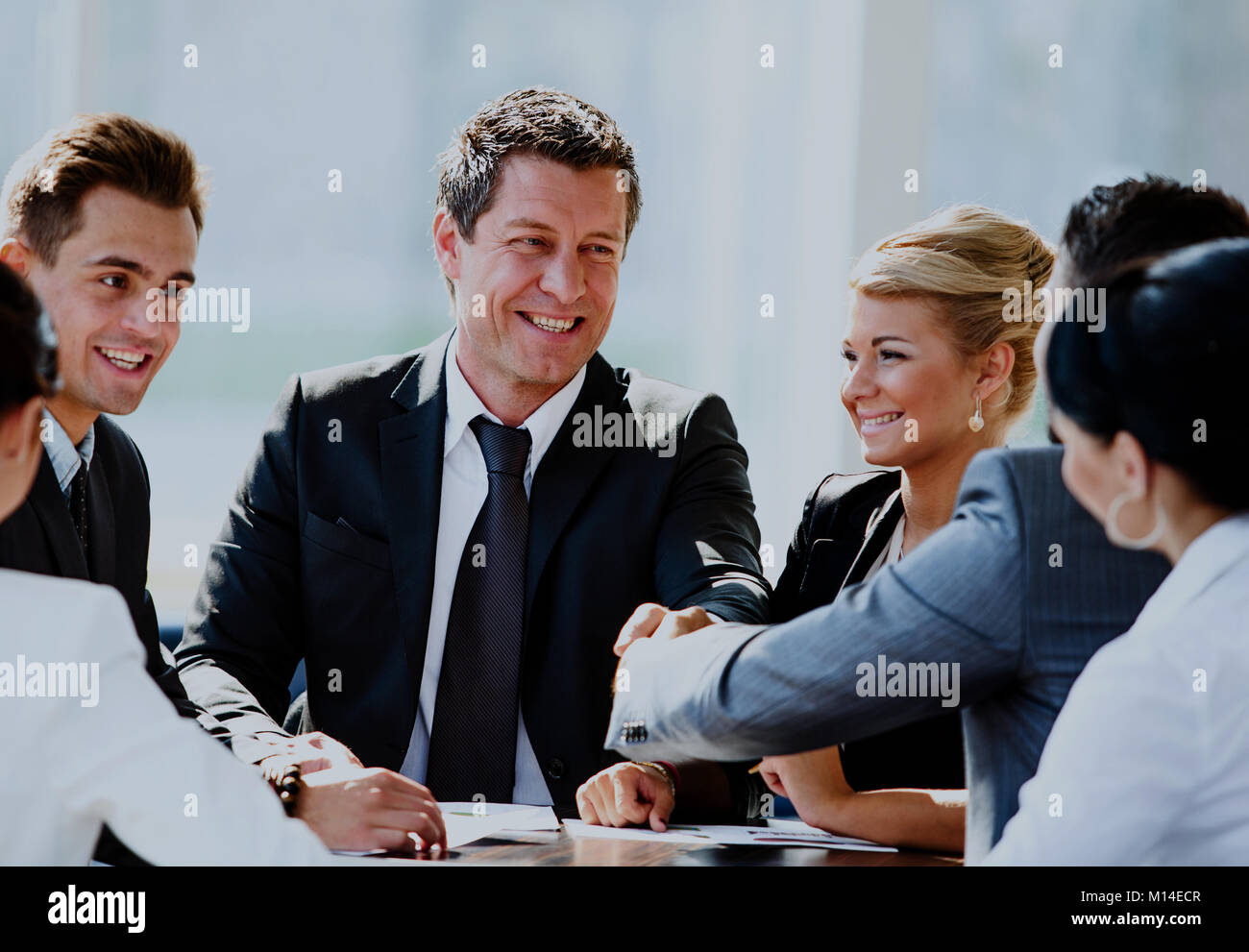 Two businessmen handshaking after striking grand deal Stock Photo - Alamy