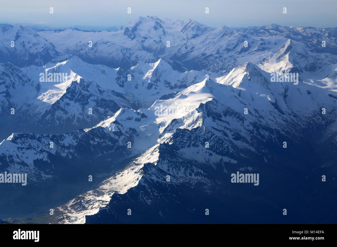 Snow-capped mountain peaks of the Alps to the altitude of the aircraft ...