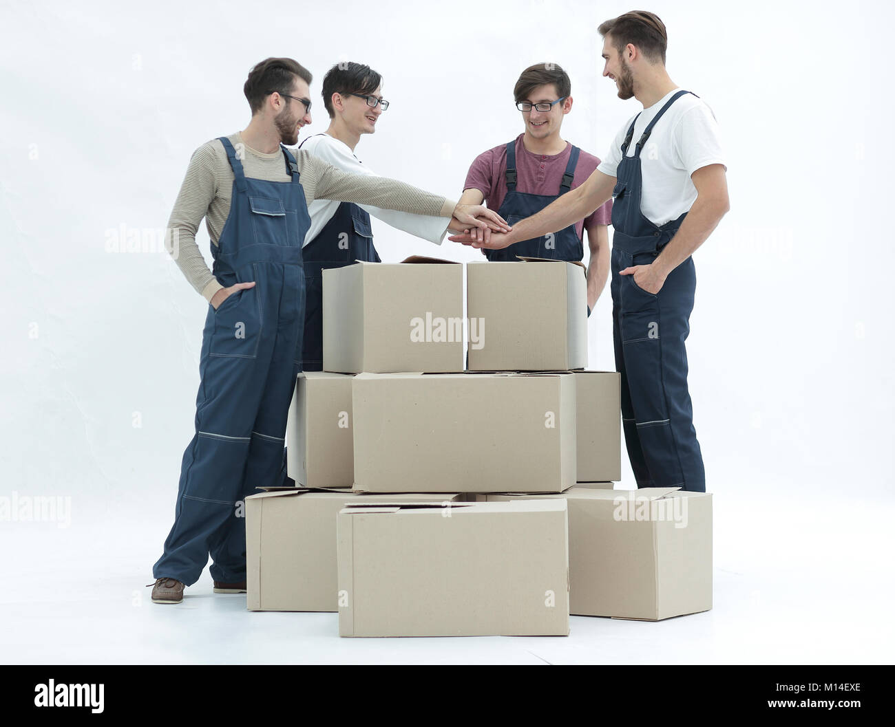 Delivery men carrying stack of boxes. Isolated on white Stock Photo - Alamy