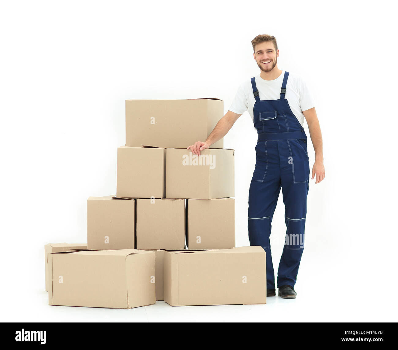 Young man carrying a box to the pile of boxes Stock Photo - Alamy
