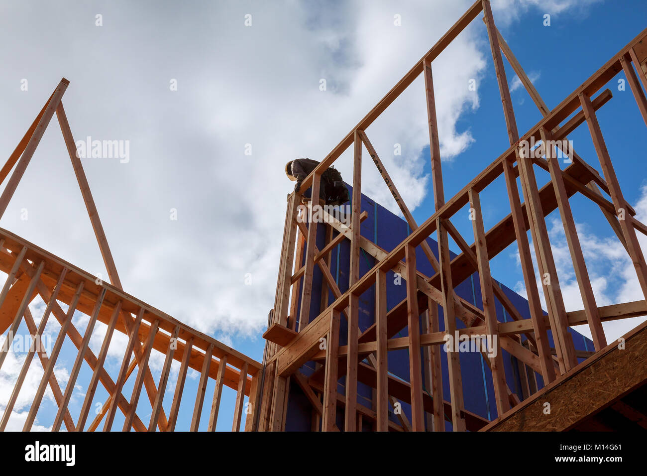 carpenter at work with wooden roof construction Wood Building frame ...