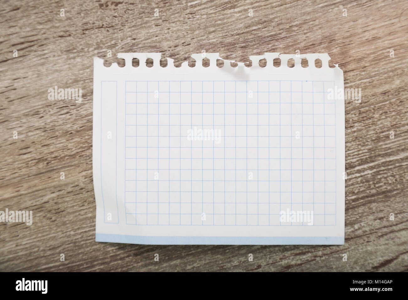 Torn-off sheet of notebook on table Stock Photo - Alamy