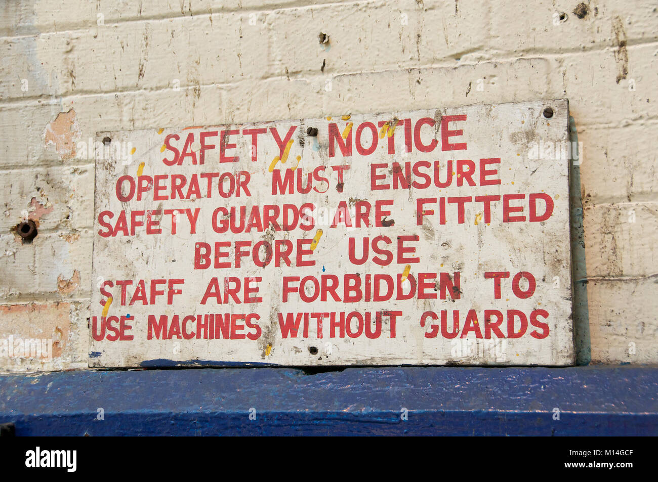 Warning notice on the workplace wall Stock Photo - Alamy