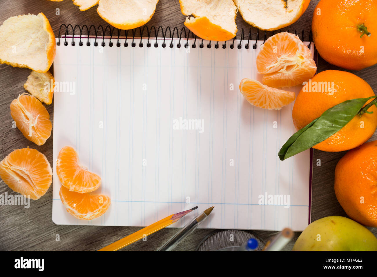 Notebook with writing utensils surrounded by fruit Stock Photo - Alamy