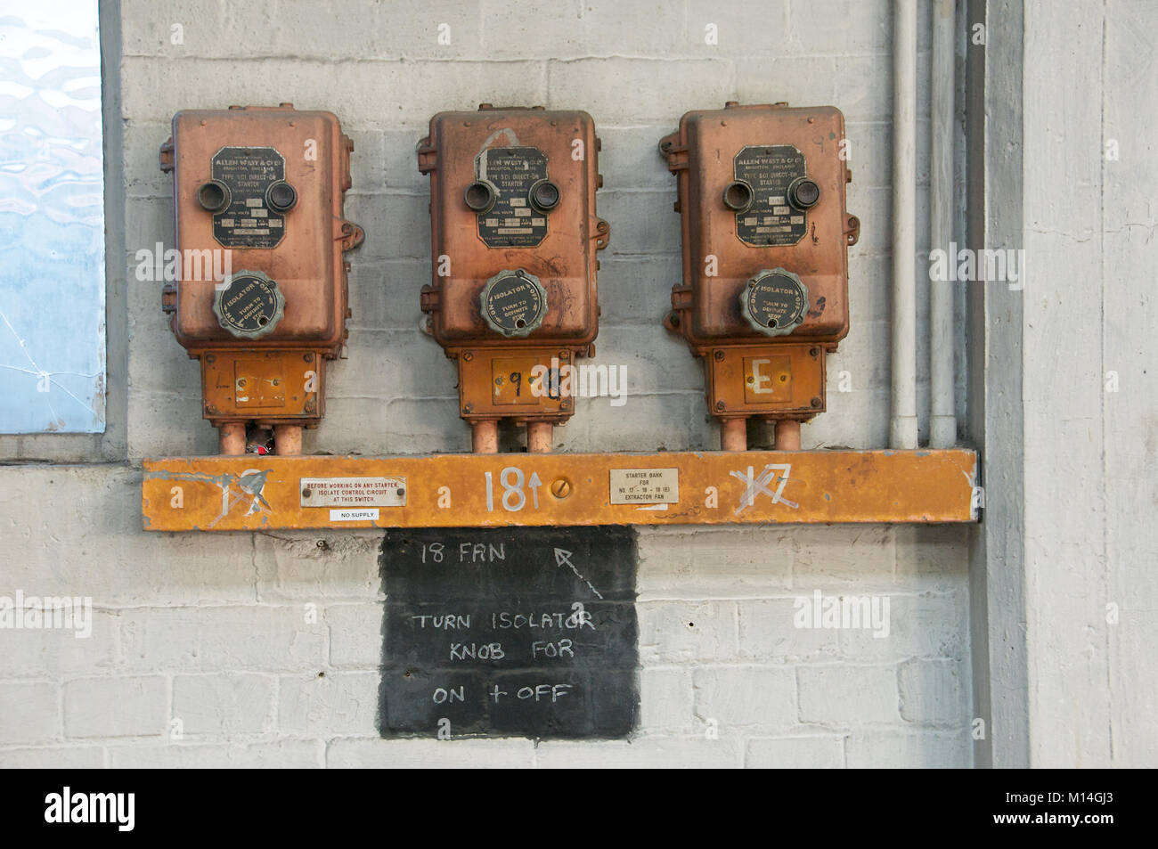 Electrical control boxes on the workplace wall Stock Photo - Alamy