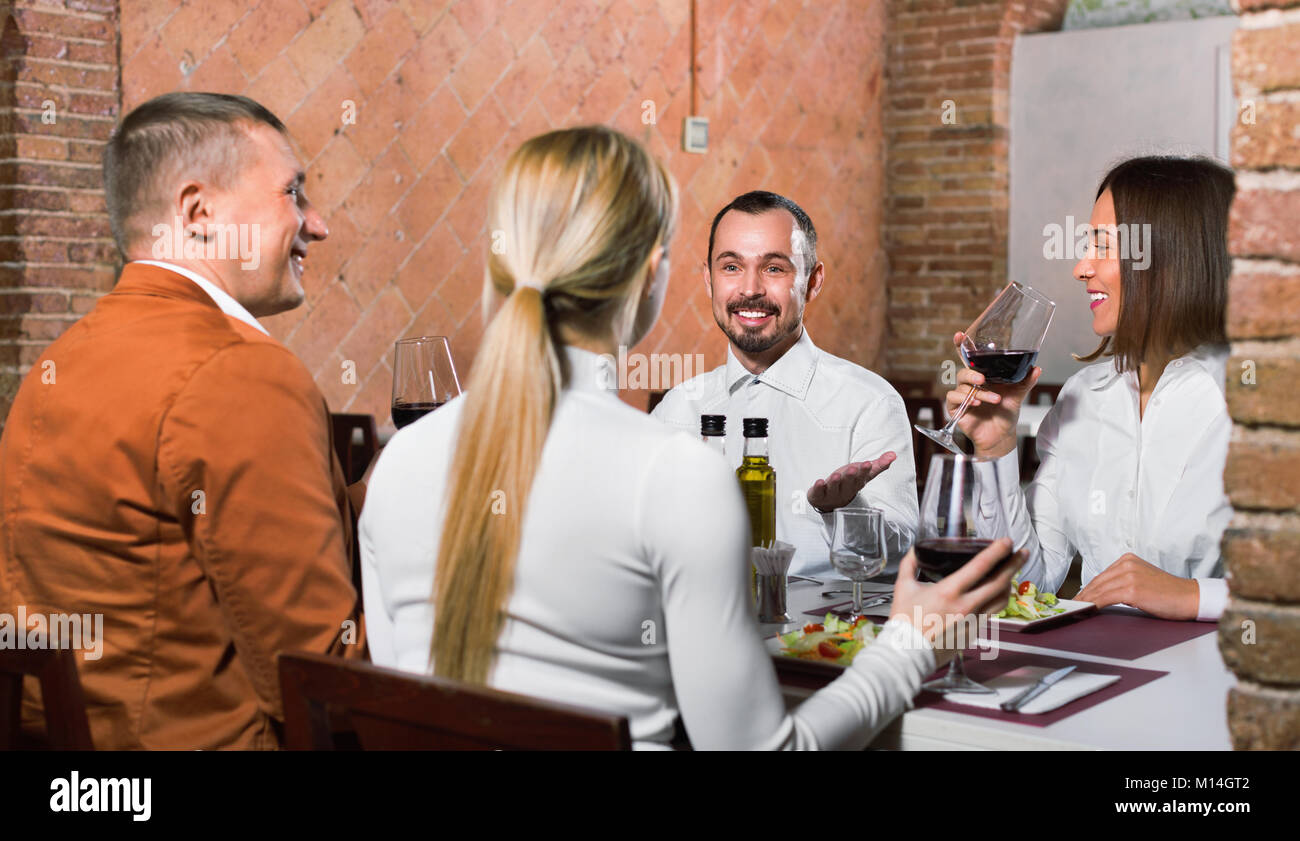 Group of positive people dining out merrily in country restaurant Stock ...