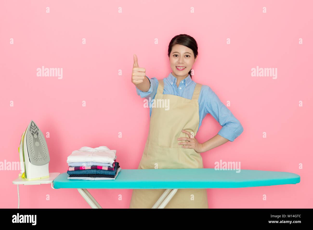 happy beautiful female house worker showing thumb up gesture looking at ...