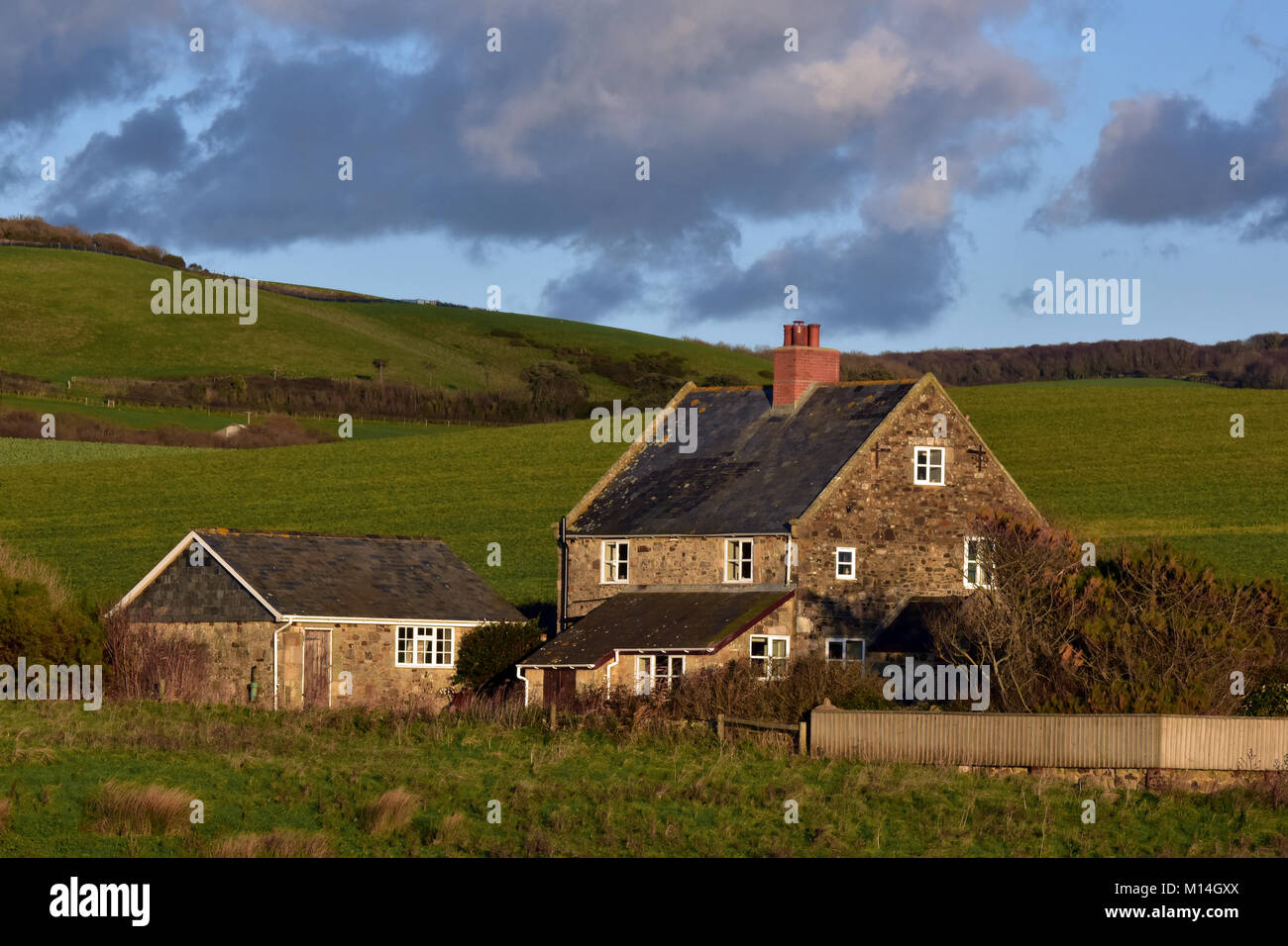 A remote farmhouse in the middle of rolling farmland and countryside on ...
