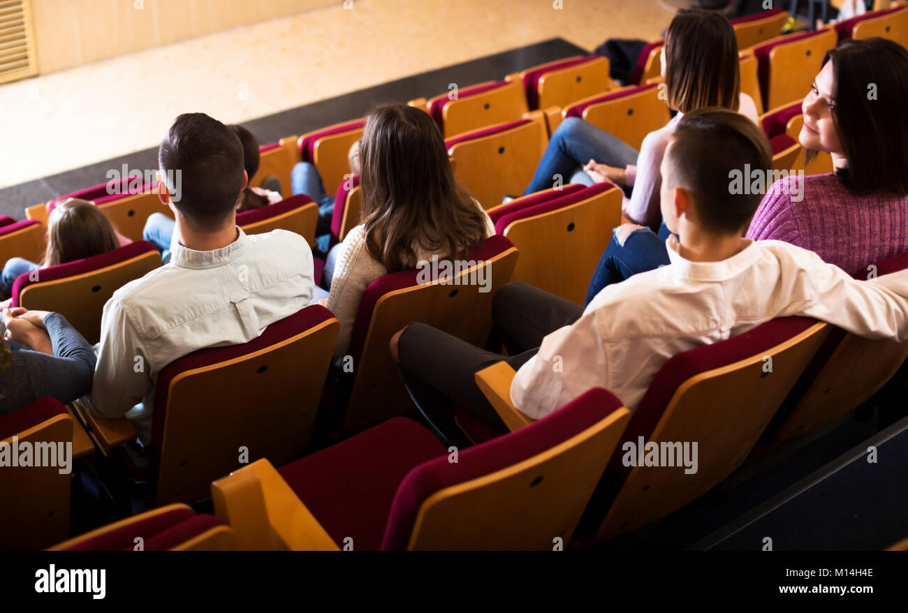 Young people waiting for movie to start in cinema Stock Photo - Alamy