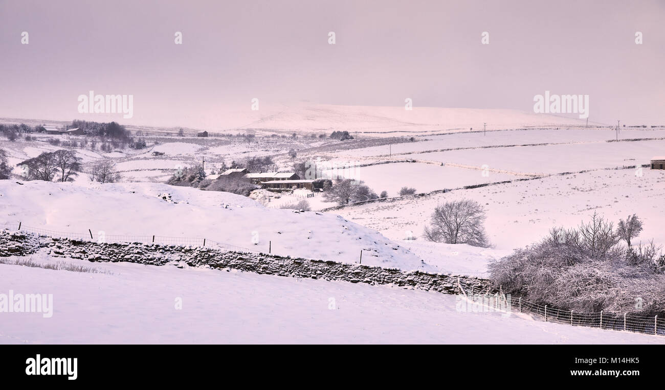 Snow covered small holding nestling amongst quarry spoil heps on Peat ...