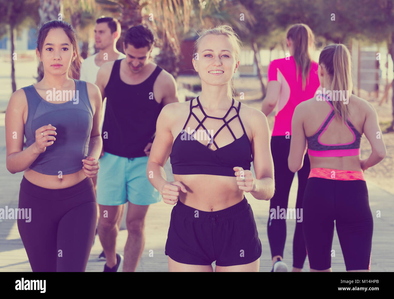Active smiling people during running training in daytime Stock Photo ...