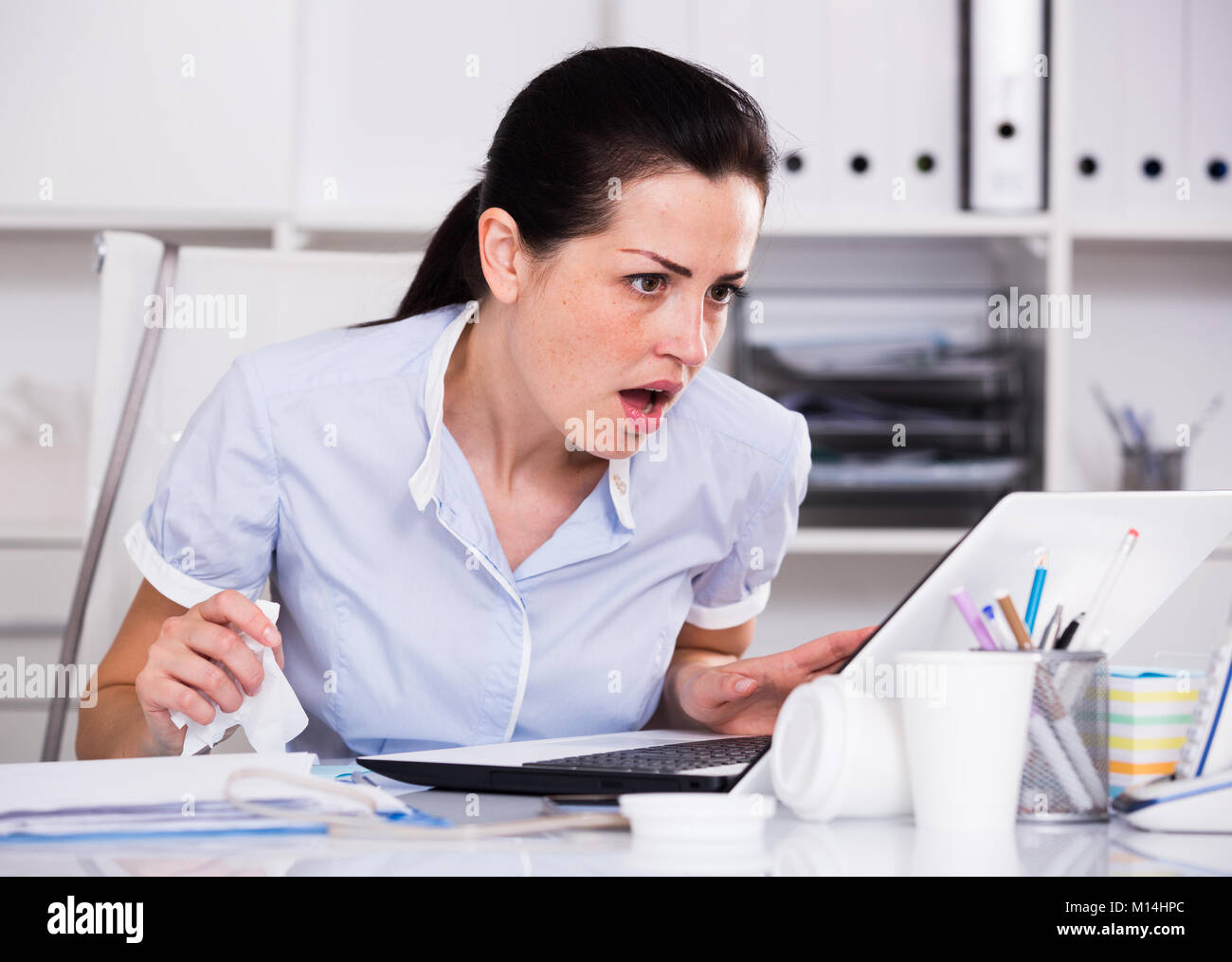 Portrait of office female have problems at work near the laptop Stock ...